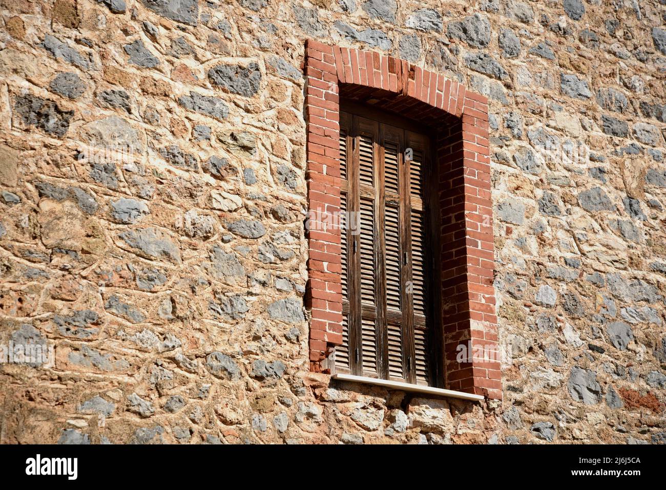 Old traditional rural house wooden window with shutters on a ...