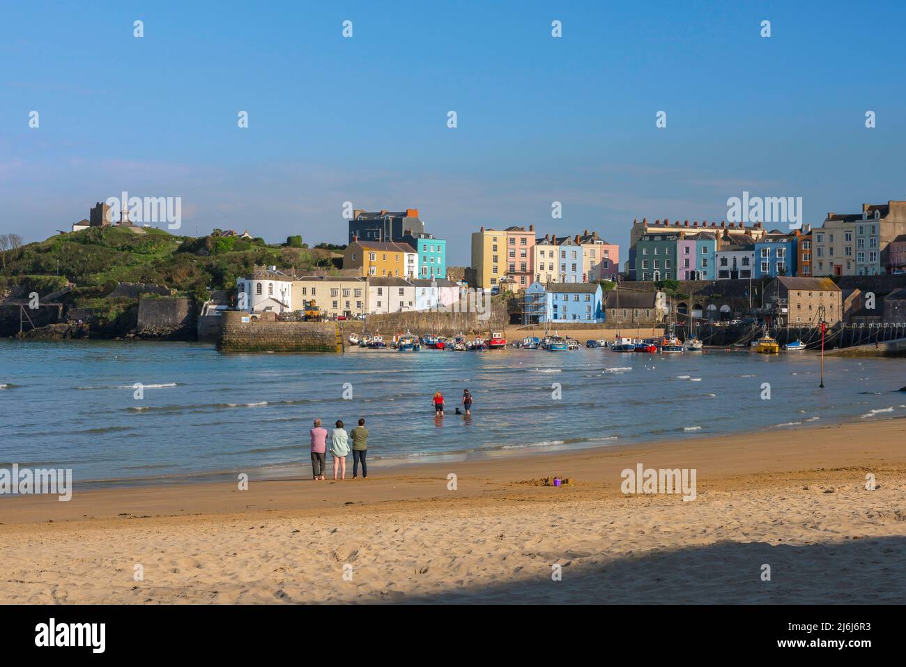Tenby North Beach, view of people standing on North Beach and looking ...