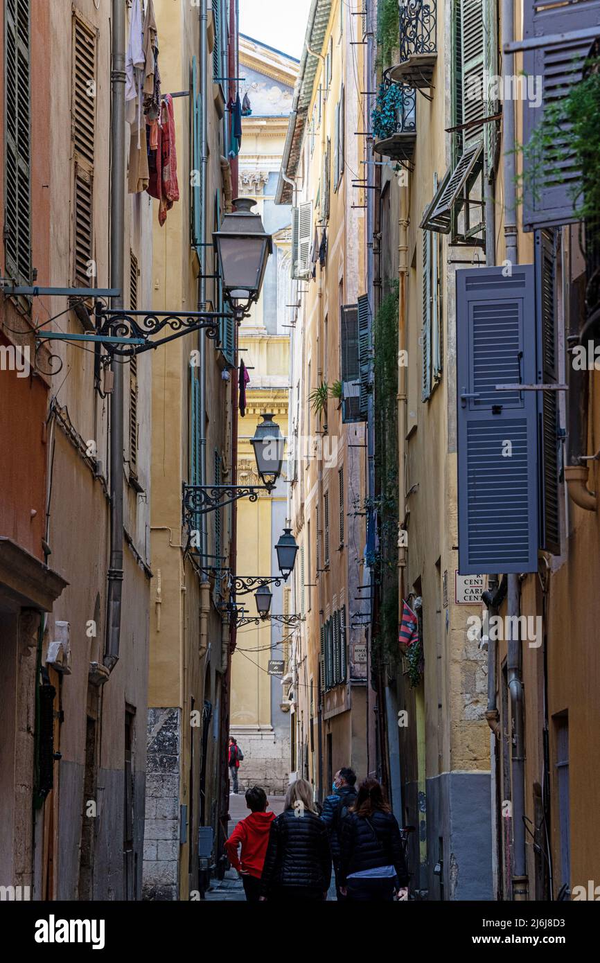 Tourists stroll down a narrow street in Nice Old Town. France Stock ...