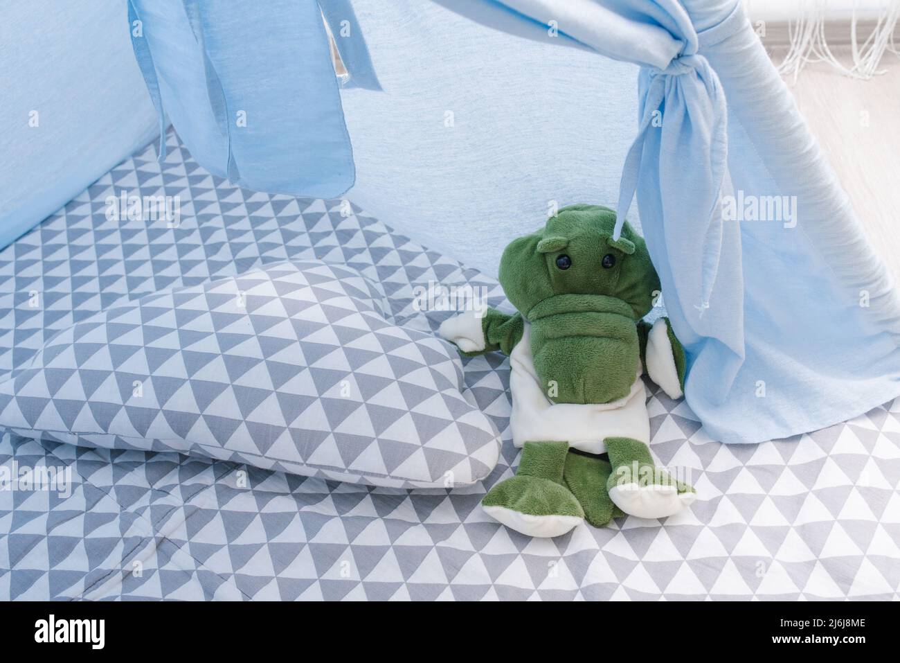 Soft crocodile toy in the children's room with copy space Stock Photo ...