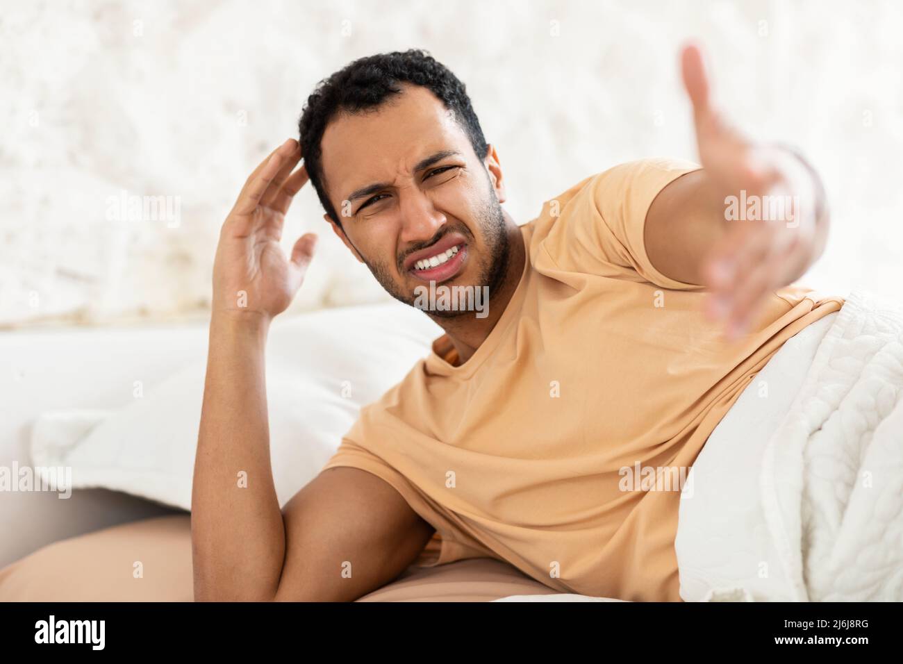 Discontented Arabic Man Looking At Camera Angrily Lying In Bedroom ...