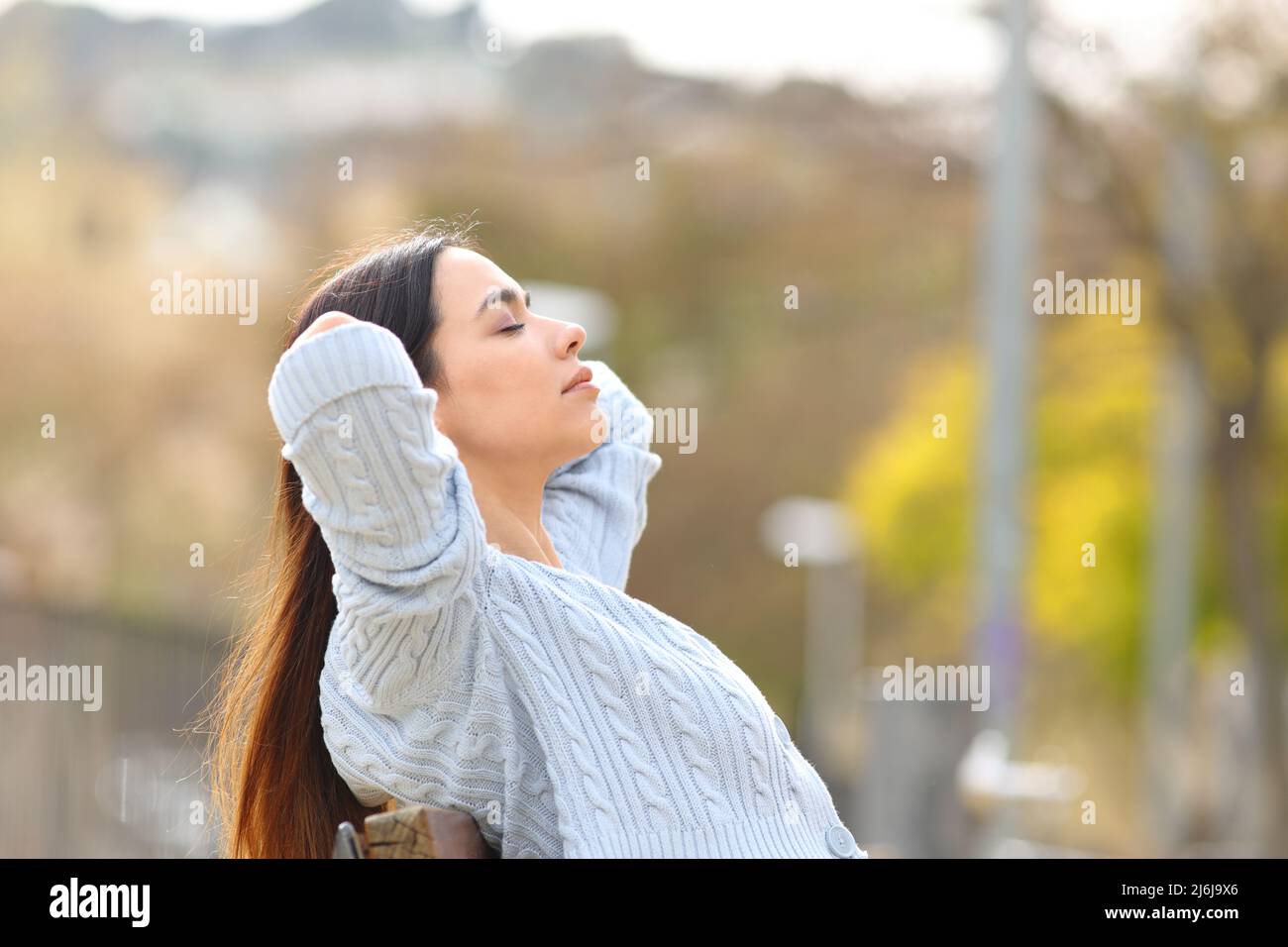 Young woman sleeping on bench hi-res stock photography and images - Alamy