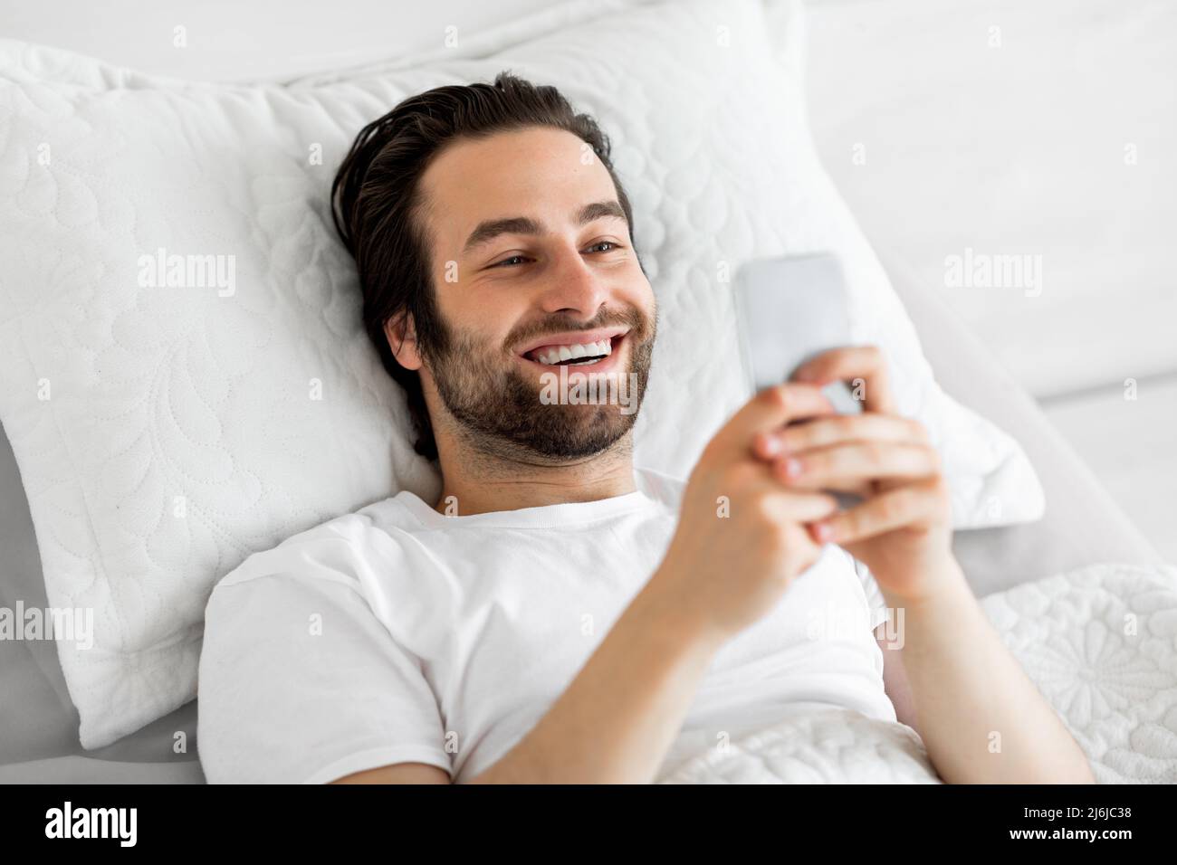 Man bed phone waking hi-res stock photography and images - Alamy