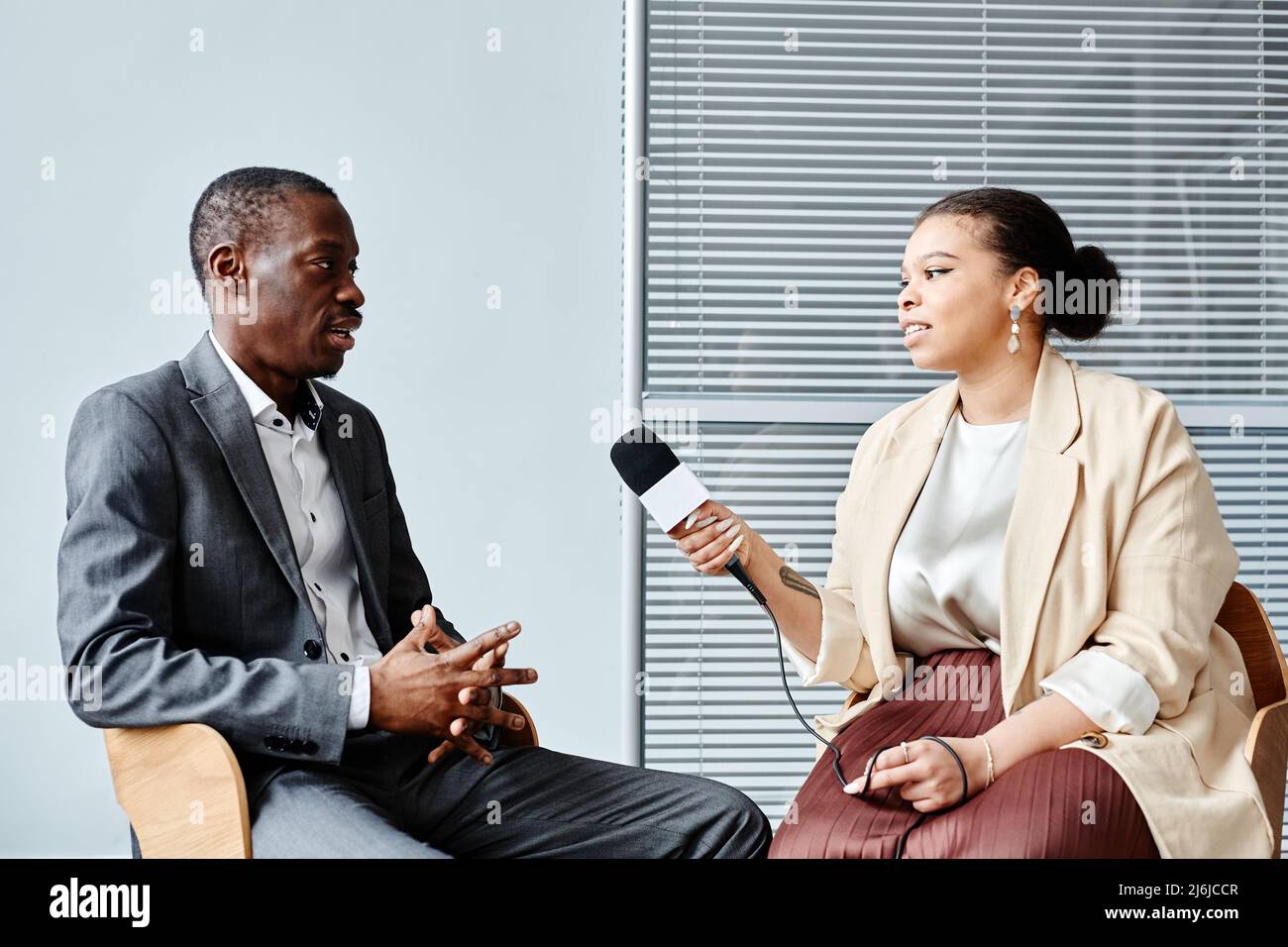 Portrait of successful African American businessman giving interview to ...