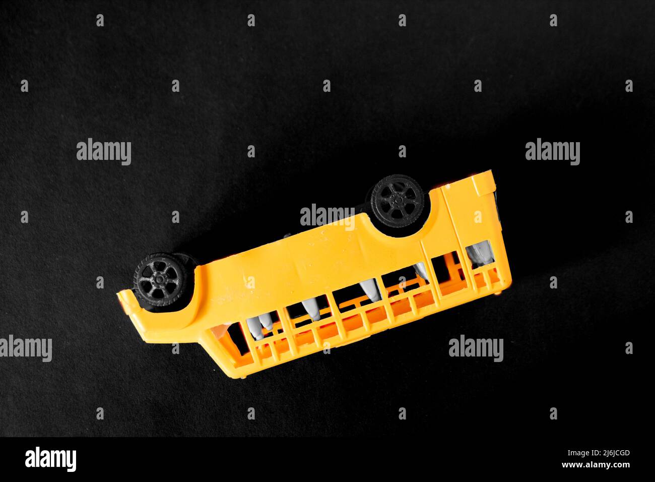 Accident with shcool bus concept. Toy bus upside down Stock Photo - Alamy