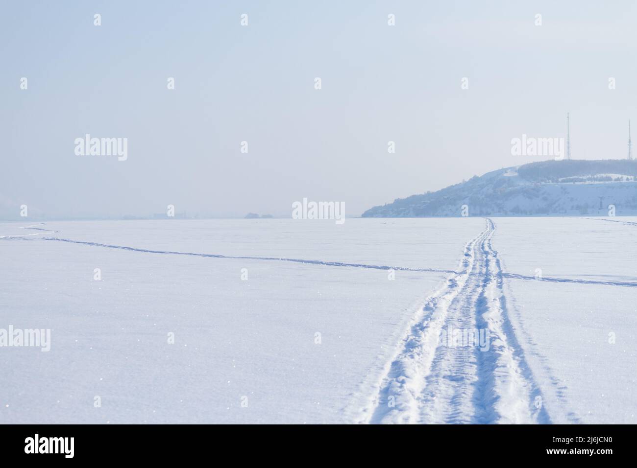 Snowmobile track marks on the snow of frozen river Stock Photo - Alamy