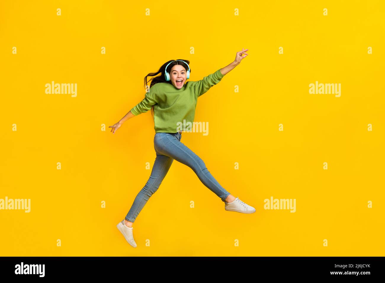 Full body profile side photo of young excited girl jump walk listen ...