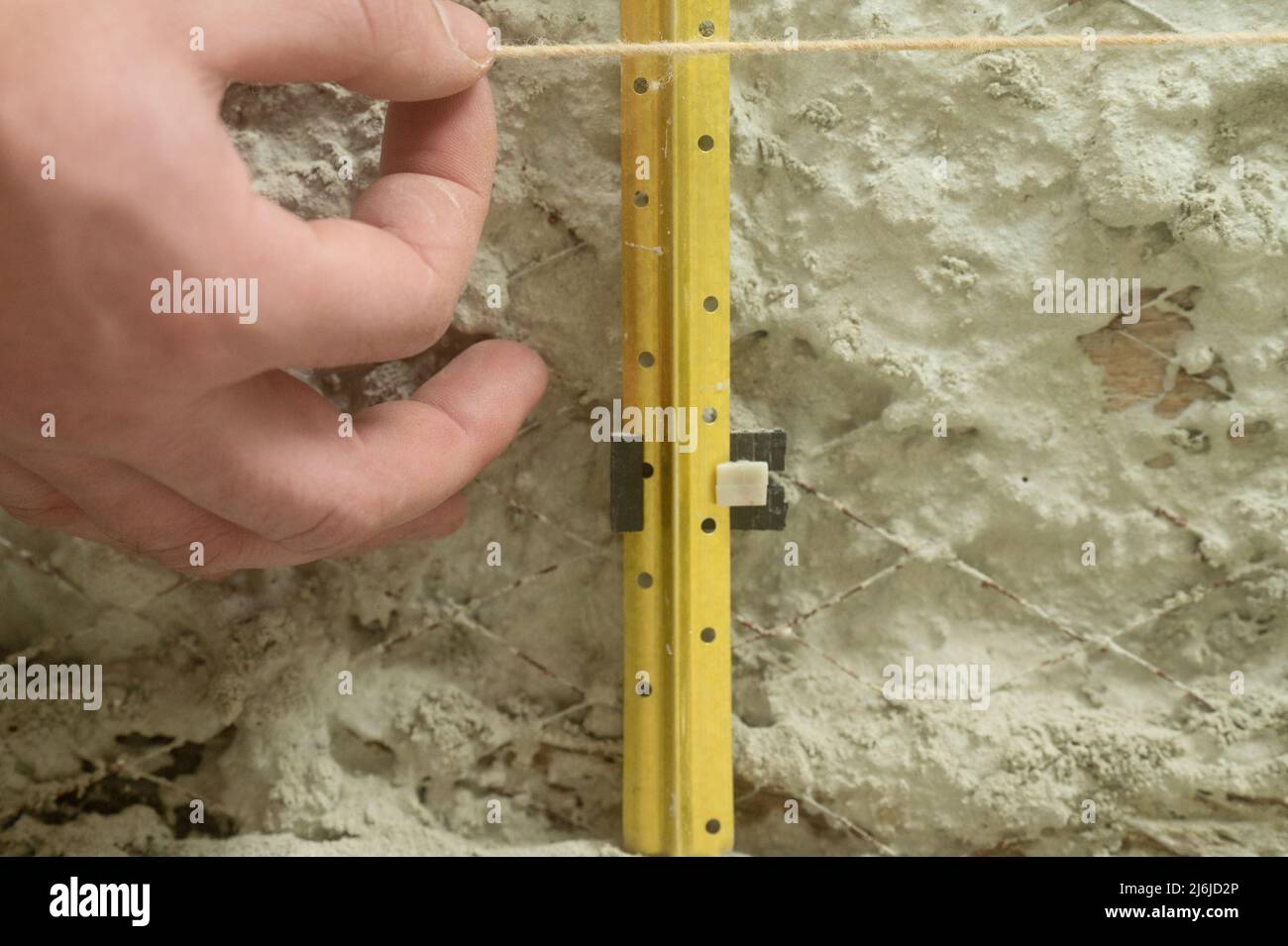 Metal guides for plaster of walls, installation of metal beacons on a ...