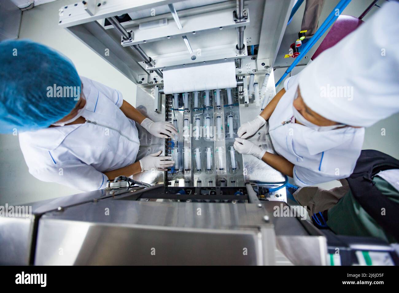 Atyrau, Kazakhstan. Medical syringe production plant. Two asian women ...