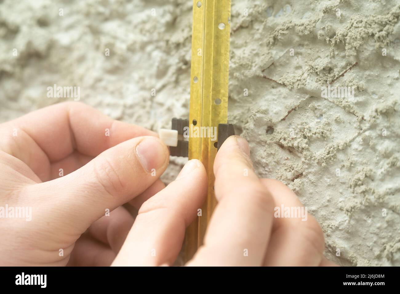 Metal guides for leveling the wall with concrete mortar, installation ...