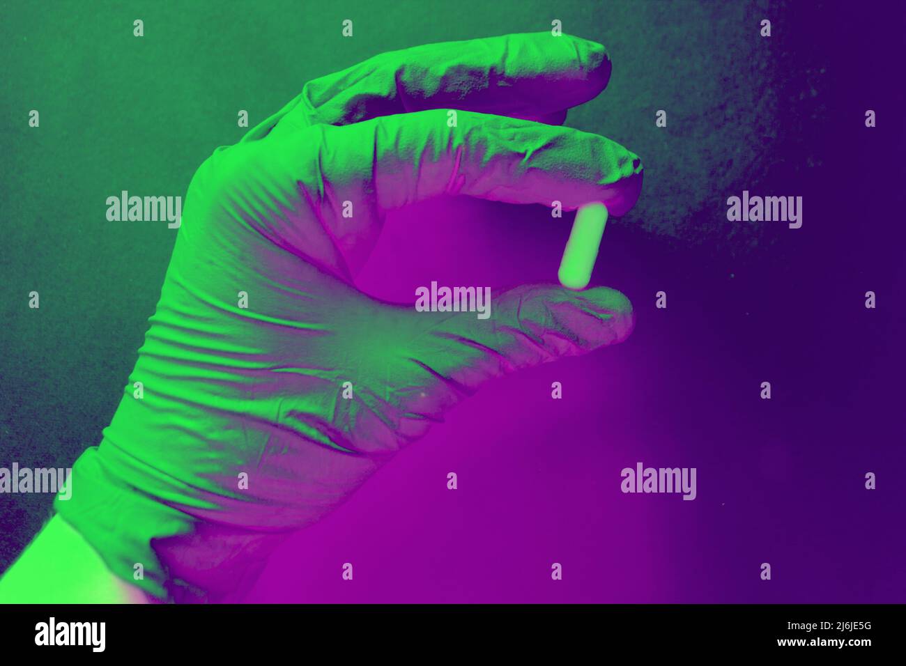 Green radioactive pills in hand Stock Photo - Alamy