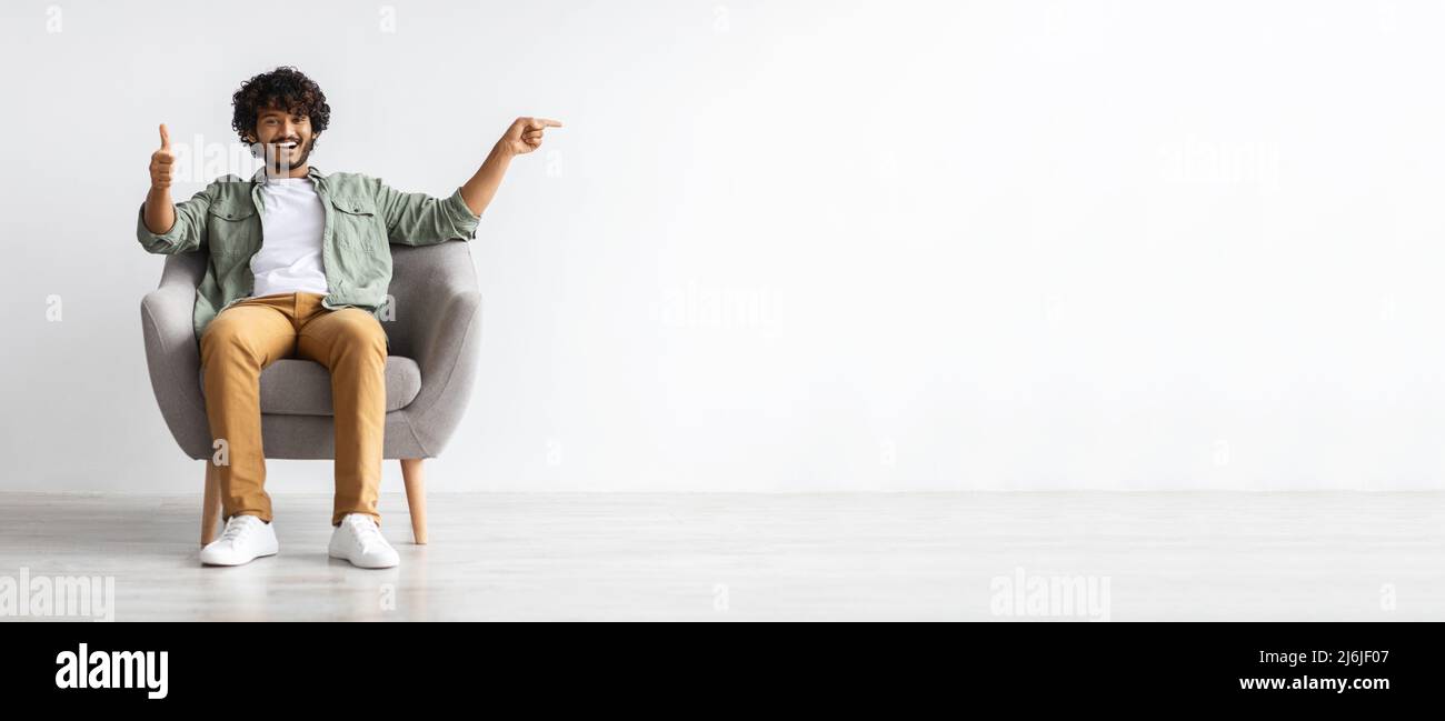 Happy indian guy pointing at copy space, panorama Stock Photo - Alamy