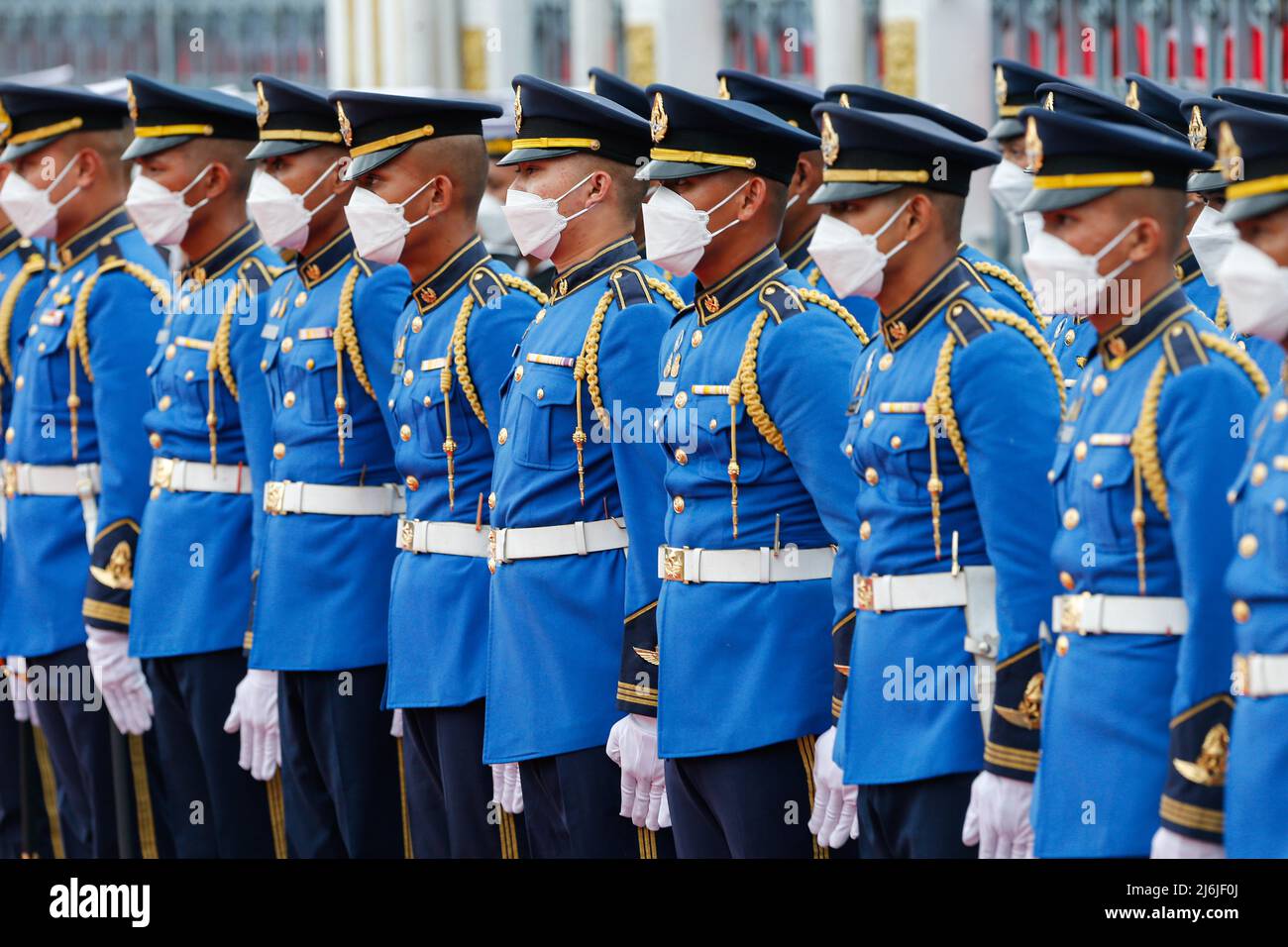 Guards of honor are seen wearing face masks as a preventive measure ...