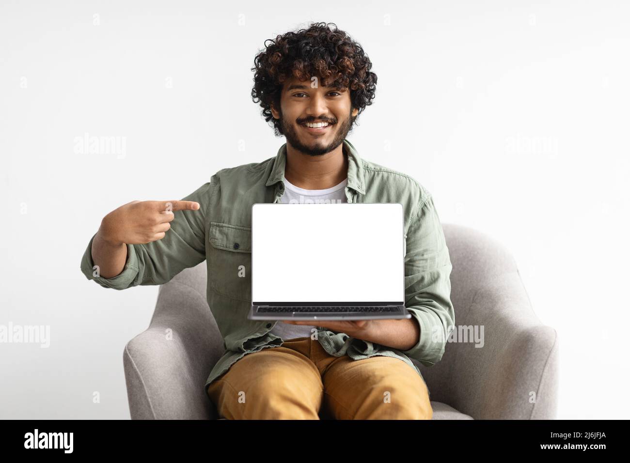 Happy indian man with laptop pointing at empty screen Stock Photo - Alamy