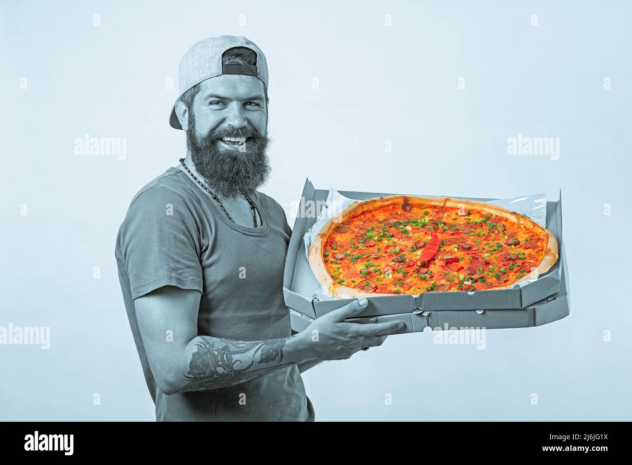 Smiling young delivery man holding pizza box Stock Photo - Alamy