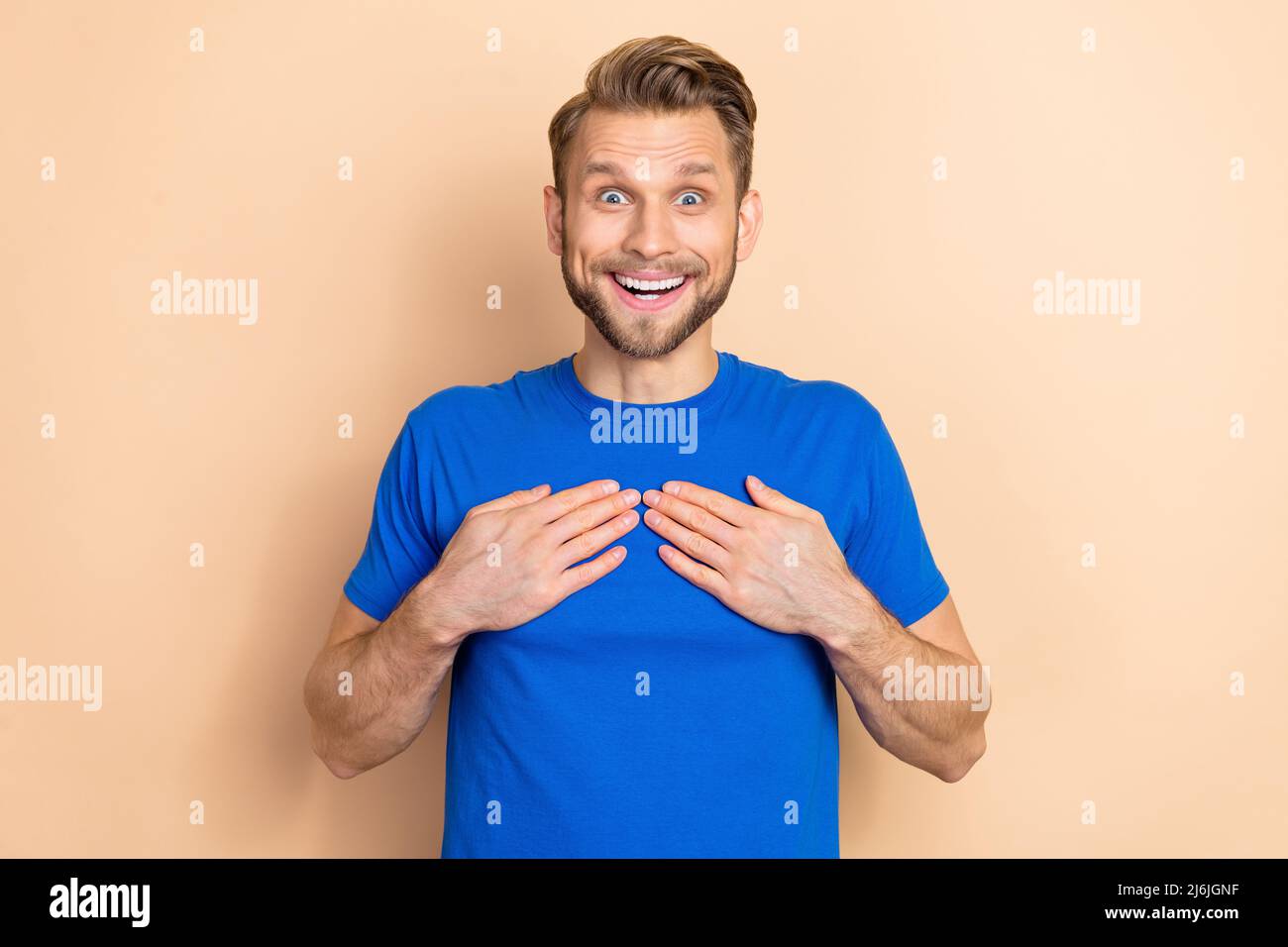 Photo of young excited man arms on chest pledge peaceful kind ...