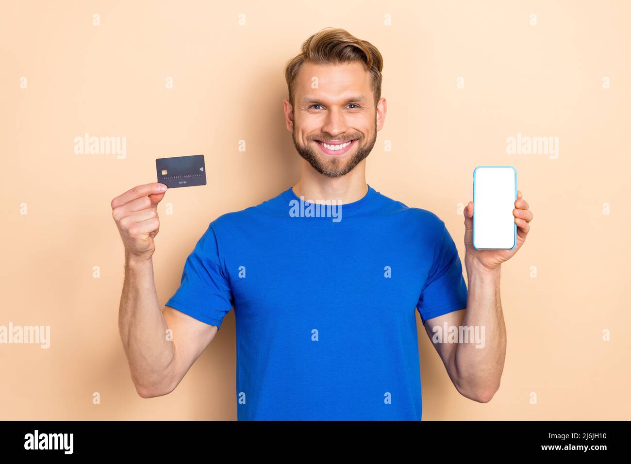 Portrait of positive handsome guy hold demonstrate debit card empty ...