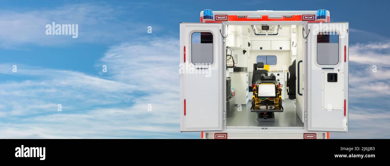 Rear view of the interior of an open ambulance in front of a blue sky ...