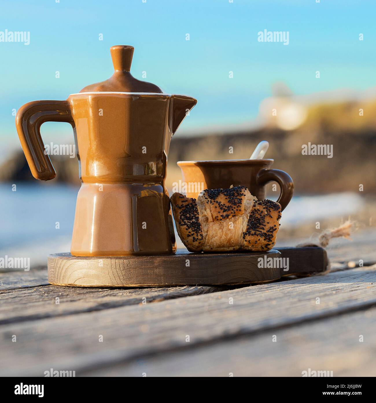 Breakfast on the beach for two. Coffee maker with cups and French ...