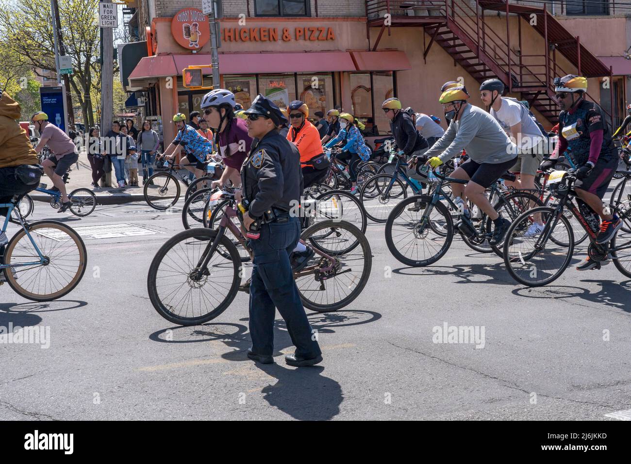 New York Police Department (NYPD) officer stops automobile traffic as ...