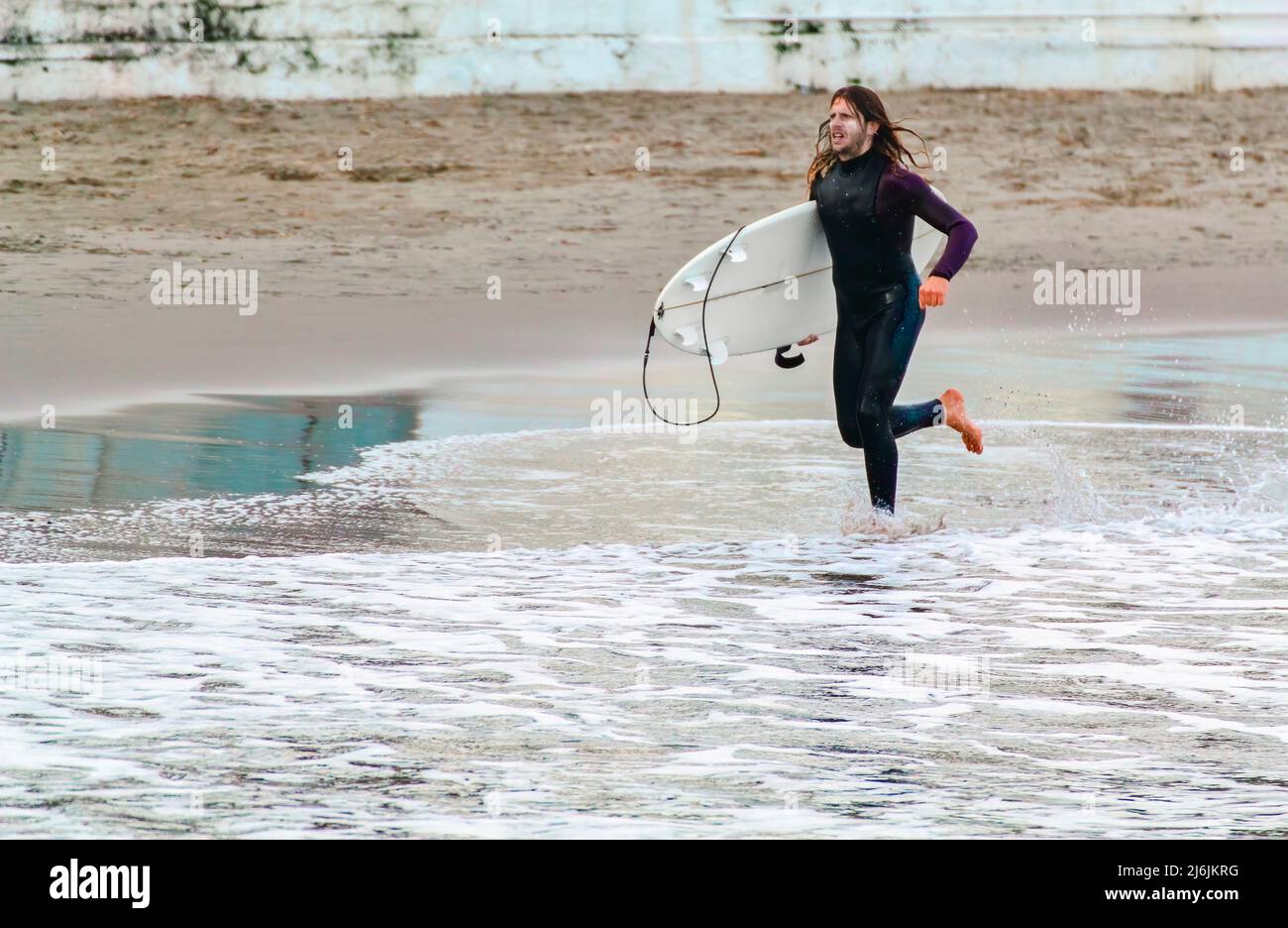 Running carrying surf board surfboard hi-res stock photography and ...