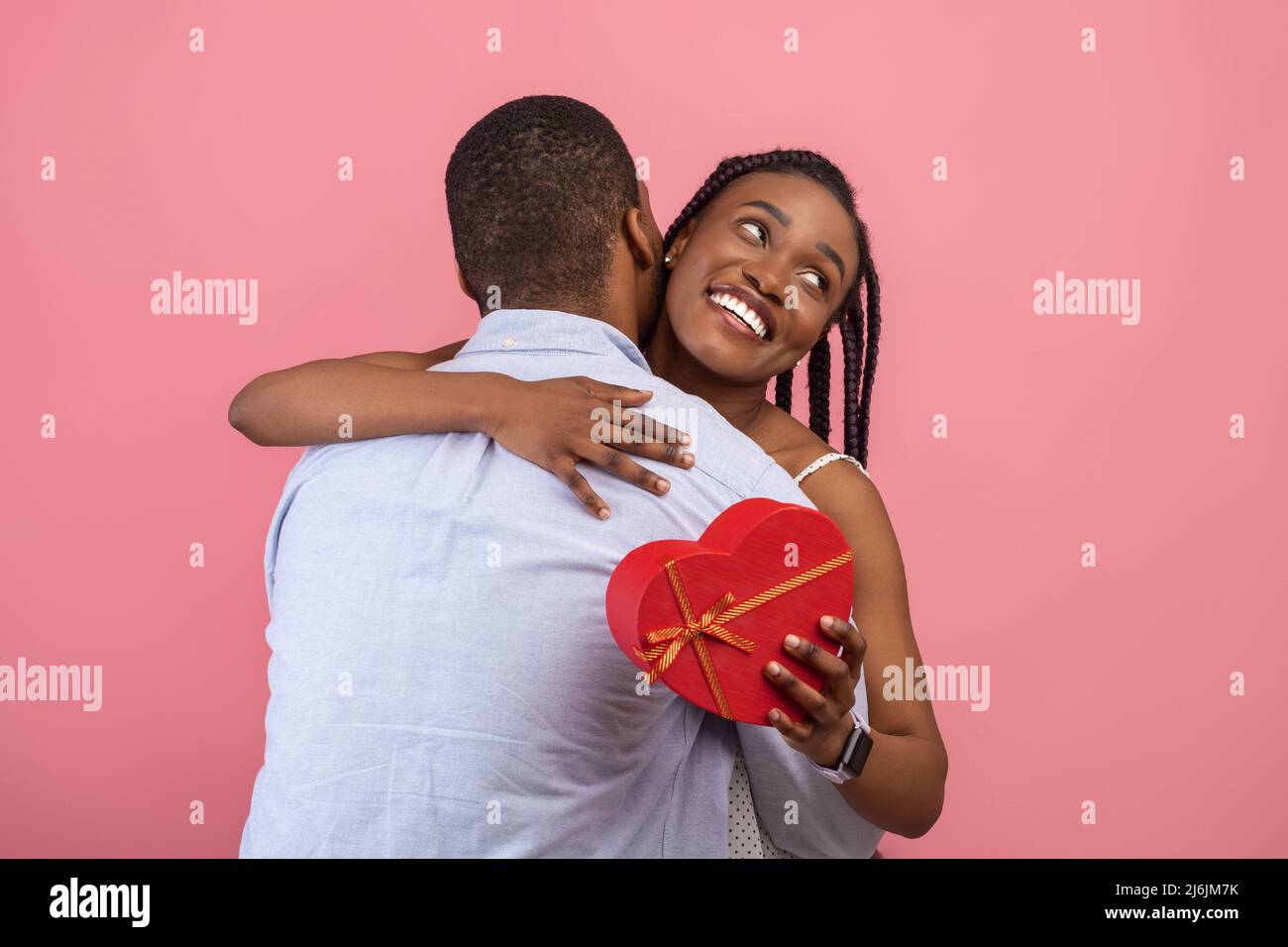Woman hugging red box hi-res stock photography and images - Alamy