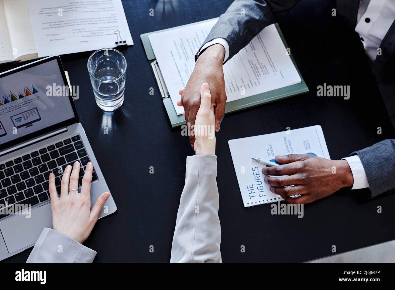 Top view closeup of African American executive shaking hands with ...