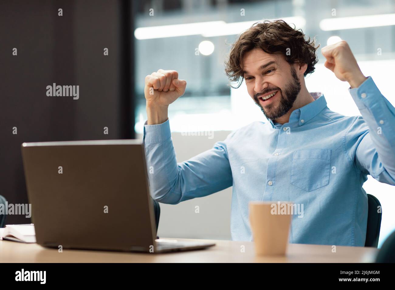 Excited businessman using pc celebrating success shaking fists ...