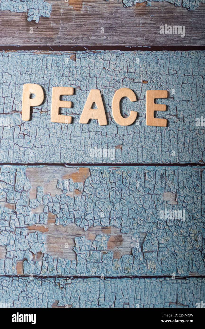 Peace text written with wooden words on a blue texture wooden board ...
