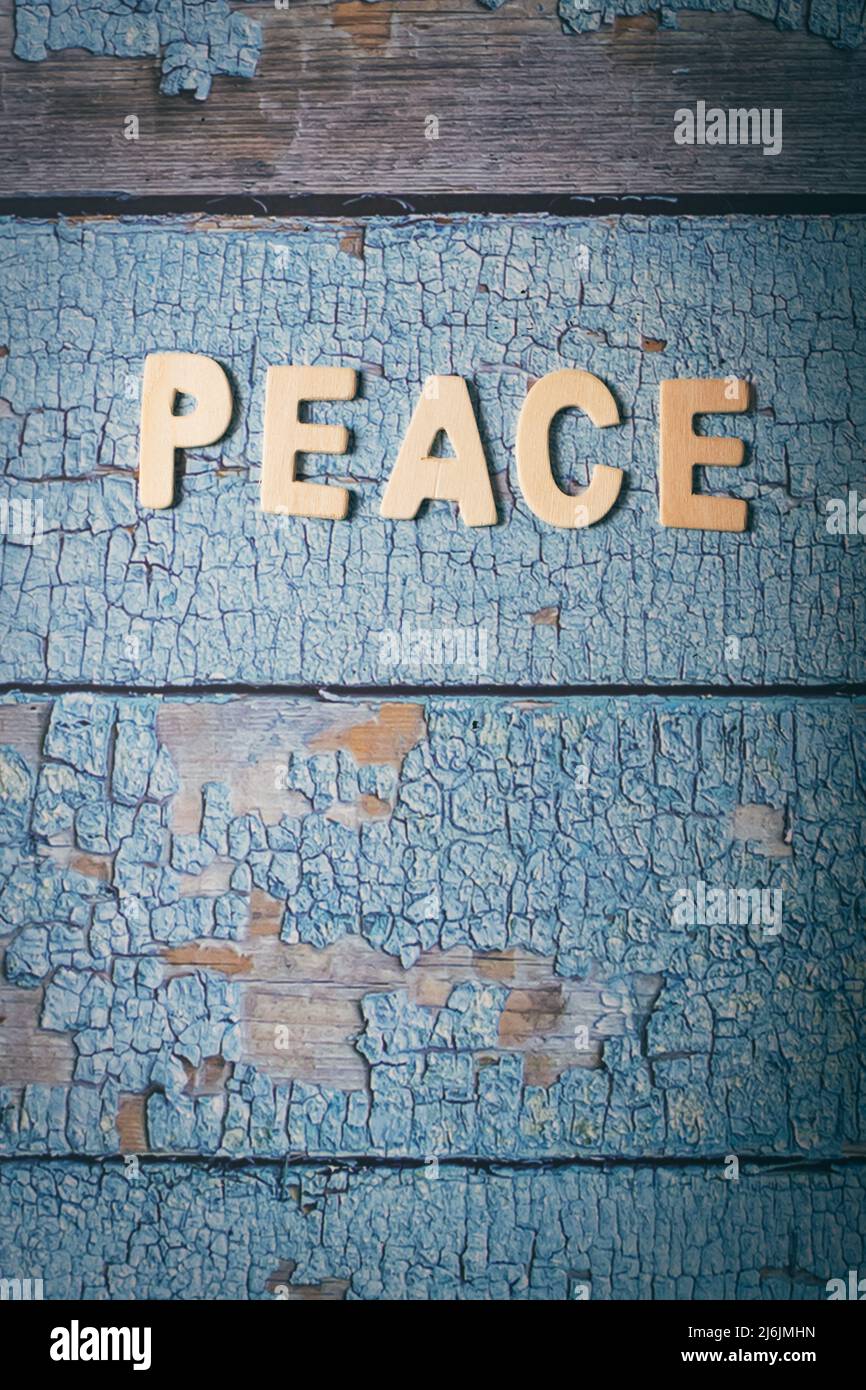 Peace text written with wooden words on a blue texture wooden board ...