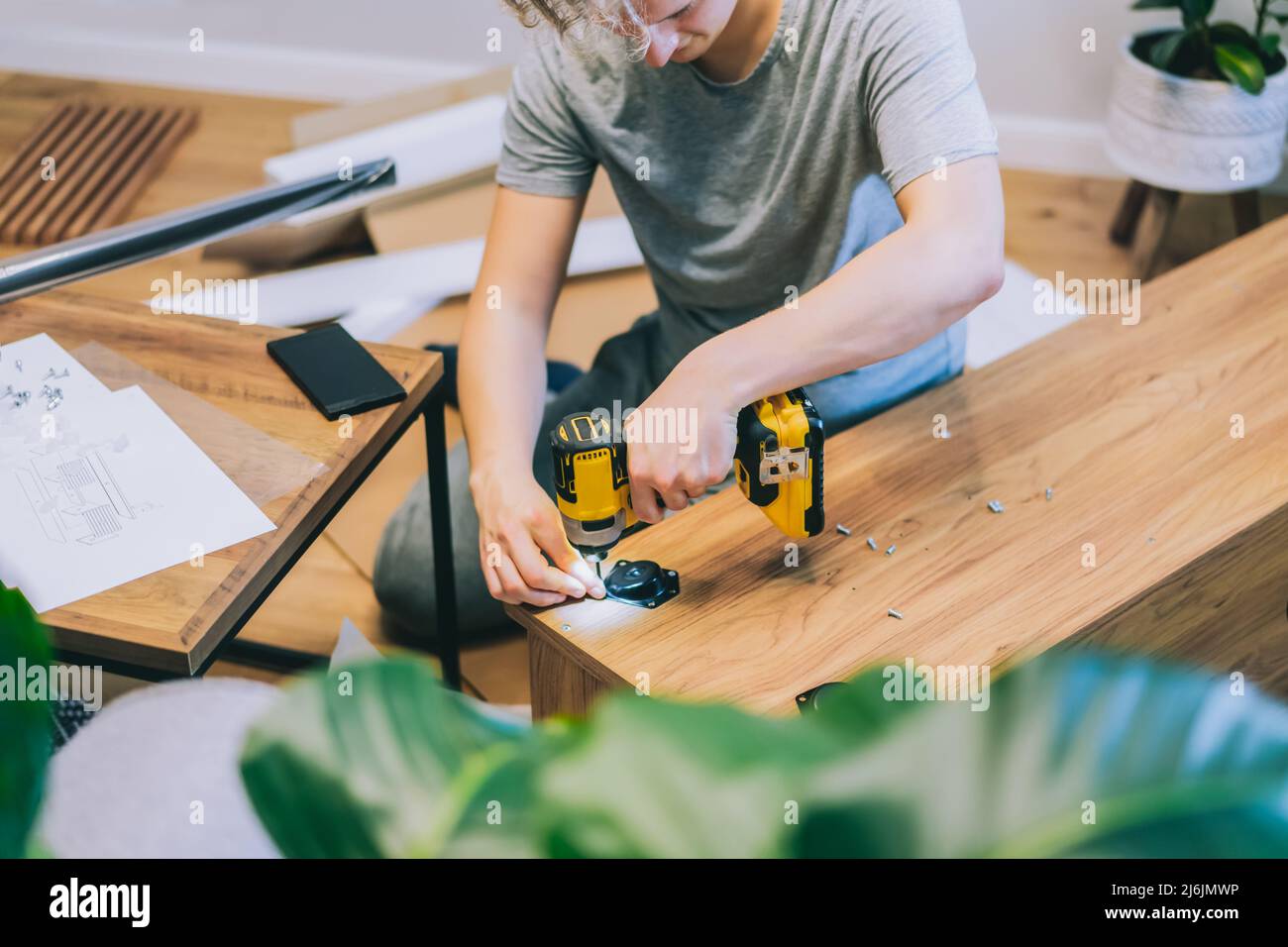 Young man using drill machine hi-res stock photography and images - Alamy