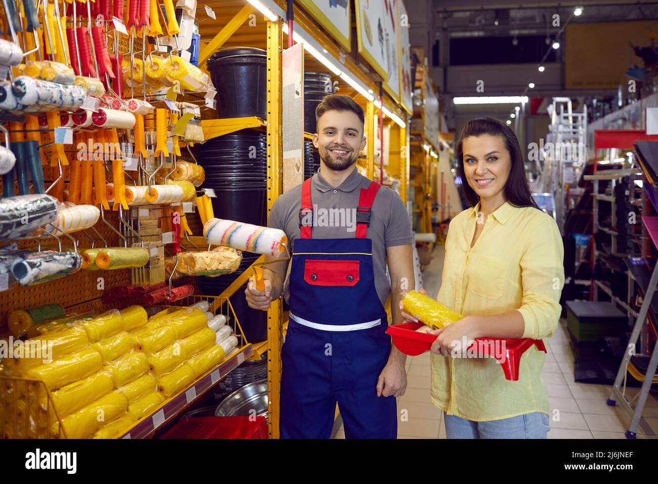 Salesman help consult woman client in building store Stock Photo - Alamy