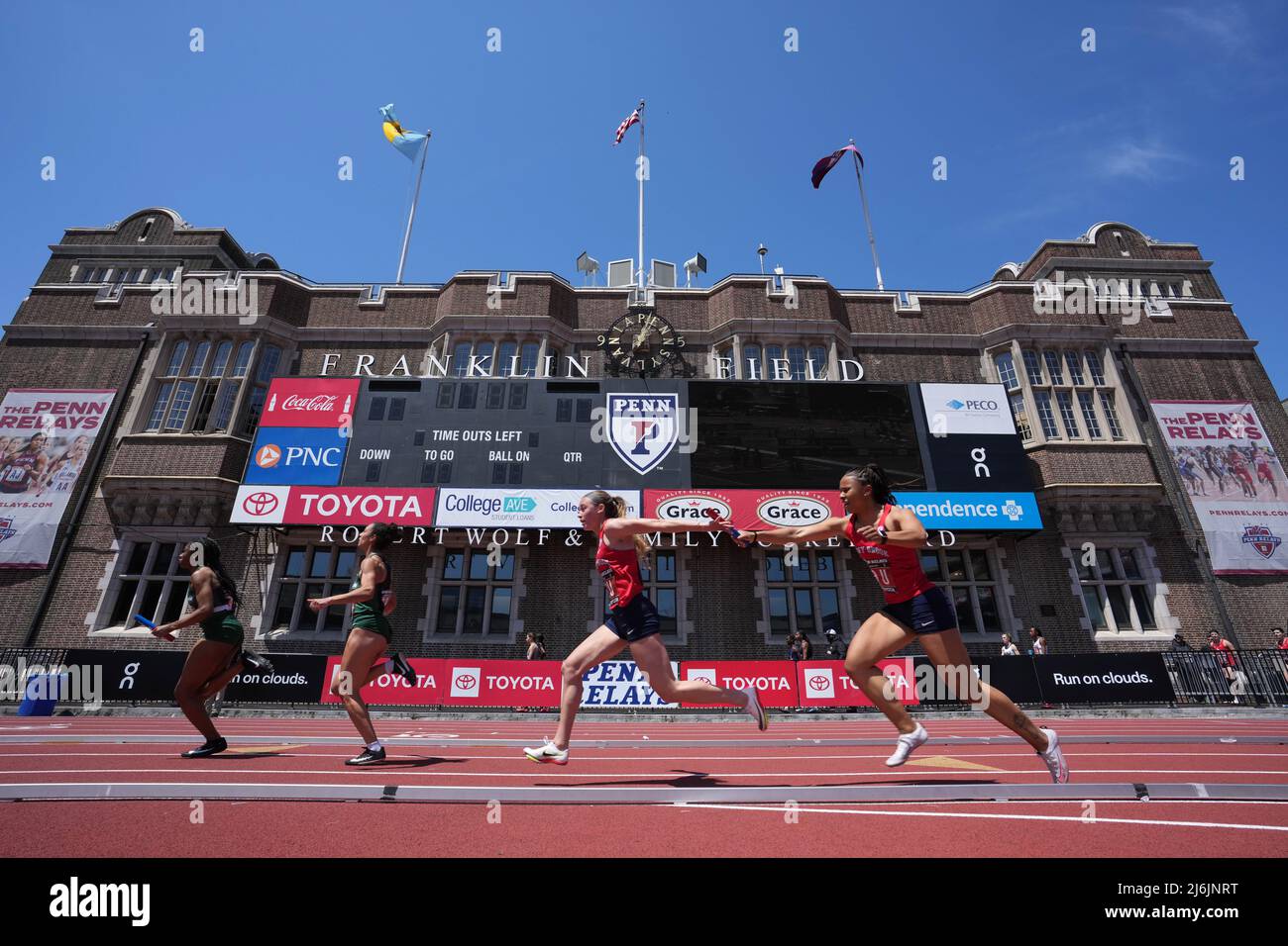 A general overall view of the handoff in a women's 4 x 100m relay heat ...