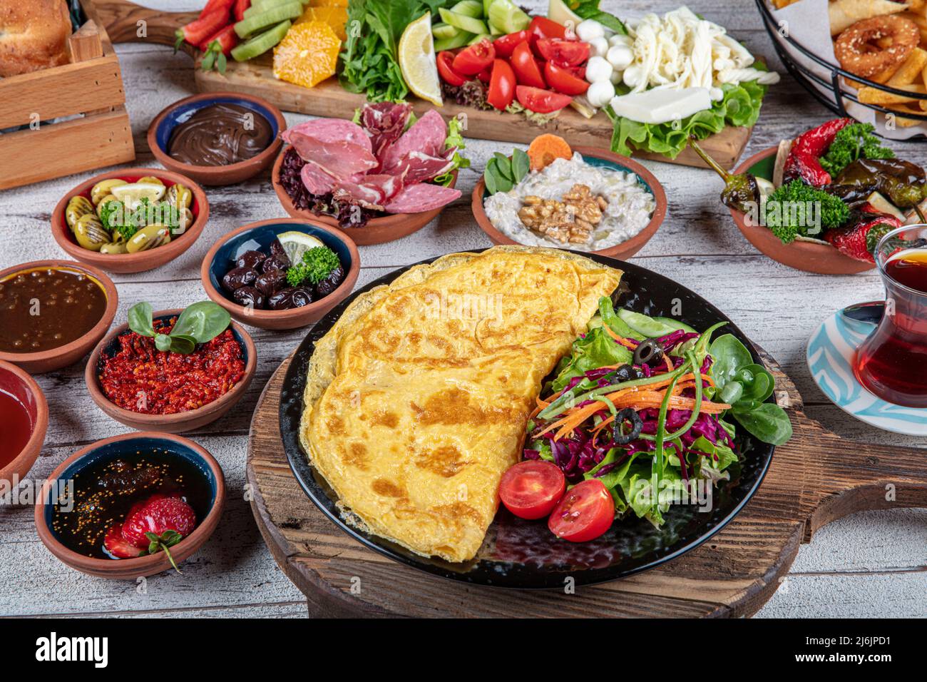 Turkish breakfast table. Pastries, vegetables, greens, olives, cheeses ...