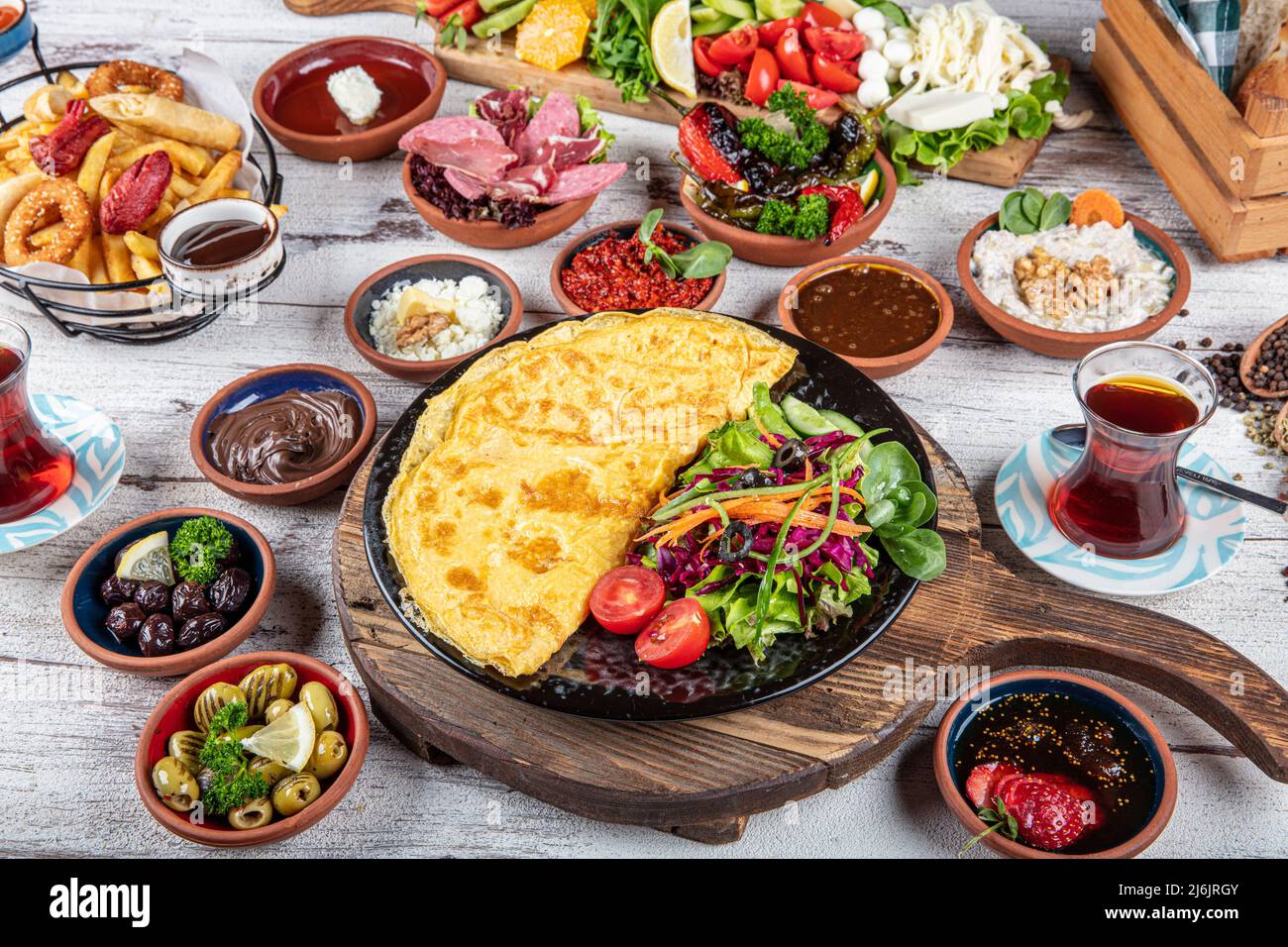 Turkish breakfast table. Pastries, vegetables, greens, olives, cheeses ...