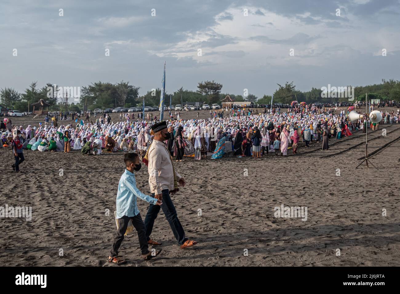 Indonesian Muslims are seen attending Eid al-Fitr prayer on sand dune ...