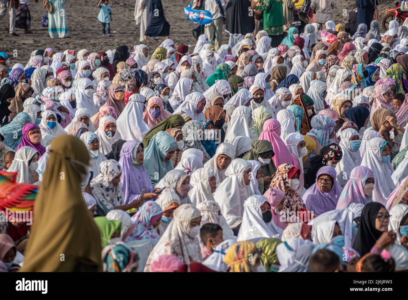 Indonesian Muslims are seen attending Eid al-Fitr prayer on sand dune ...