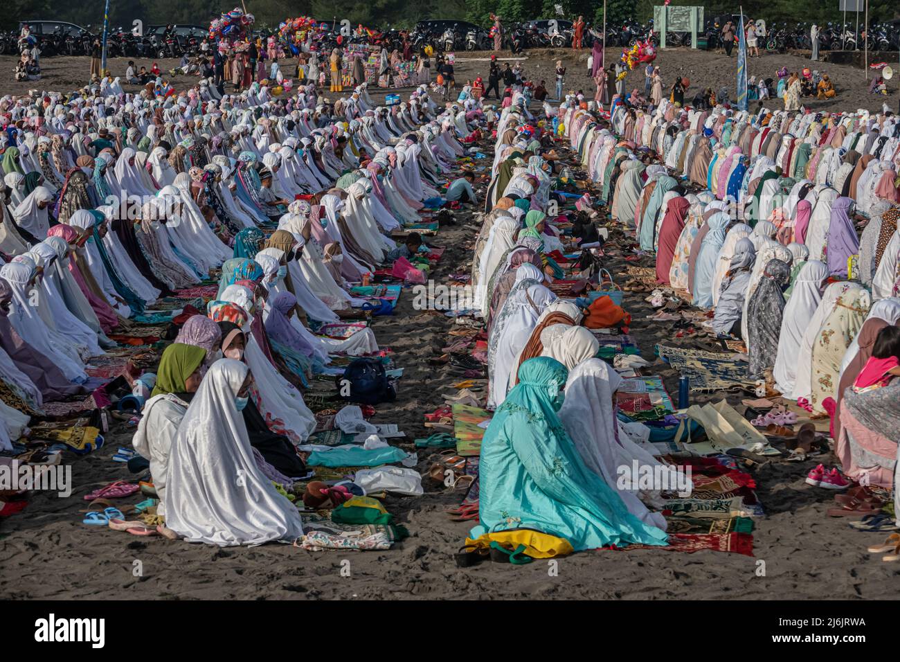 Indonesian Muslims are seen attending Eid al-Fitr prayer on sand dune ...