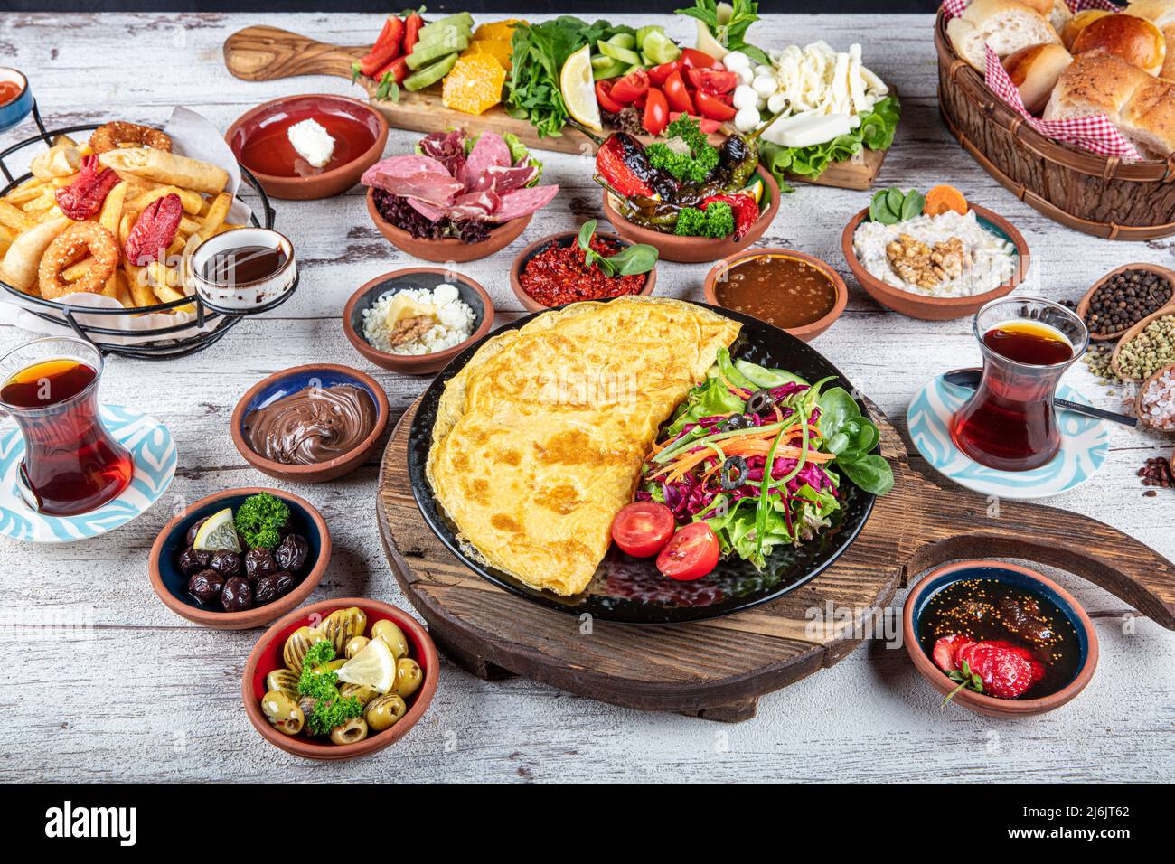 Turkish breakfast table. Pastries, vegetables, greens, olives, cheeses ...