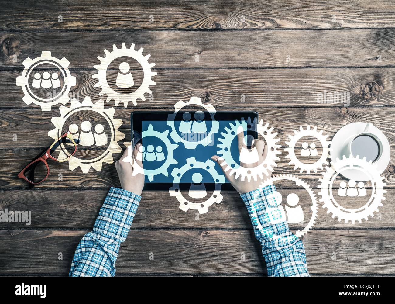 Concept of teamworking and connection with gears mechanism and tablet ...