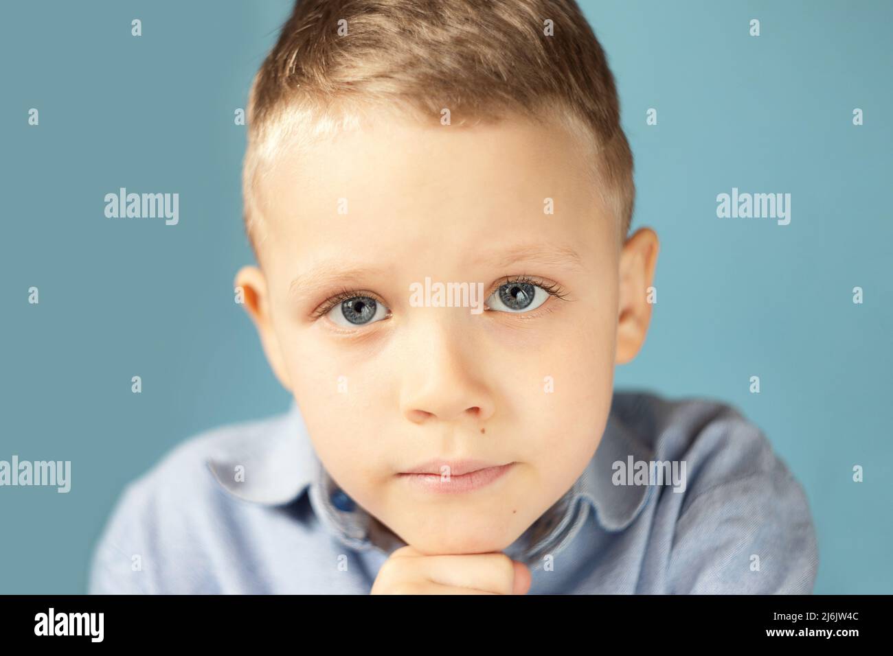 Closeup portrait of cute sad boy with blue eyes Stock Photo - Alamy