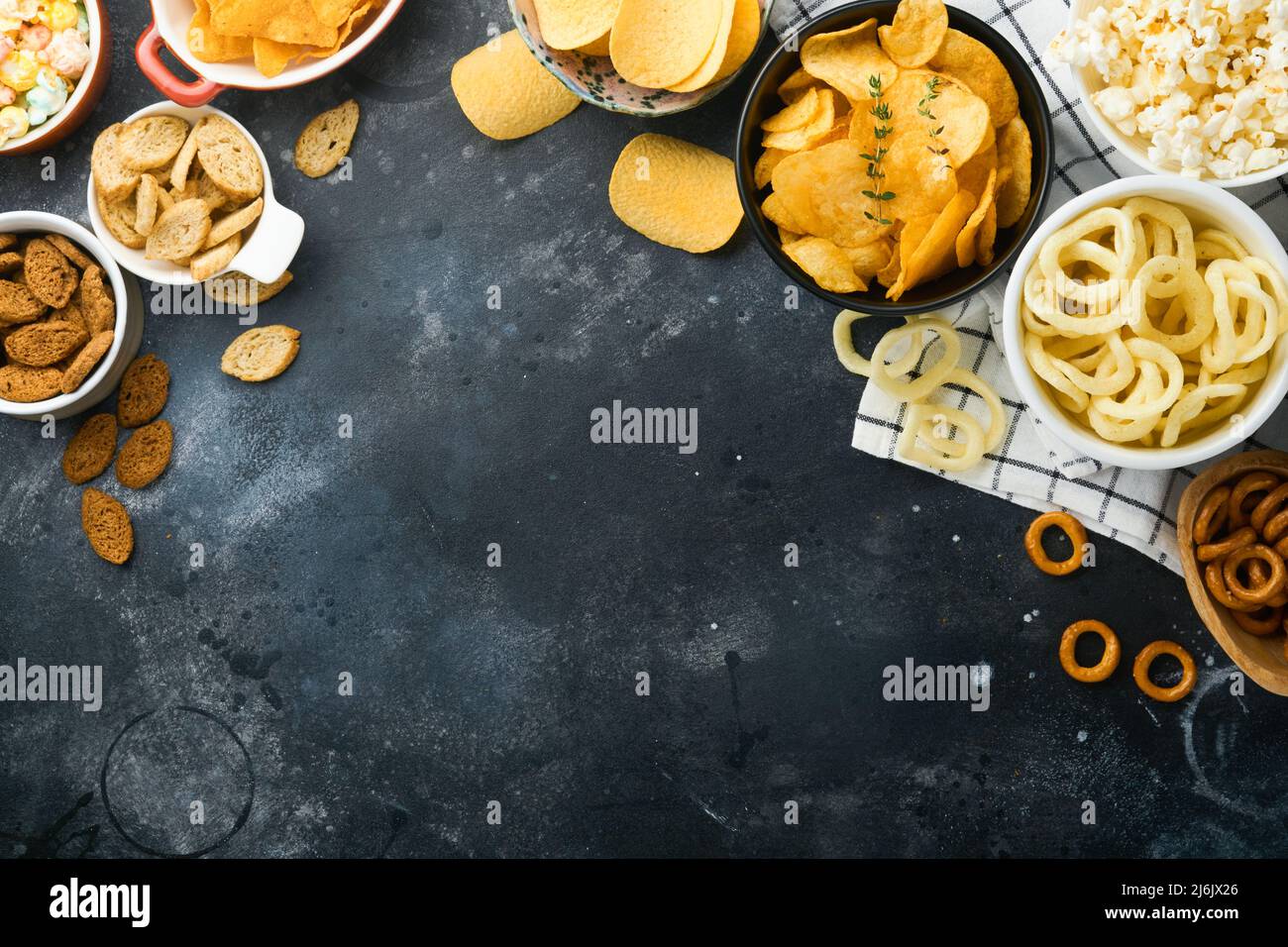 Unhealthy food. Snacks. All classic potato snacks with peanuts, popcorn ...