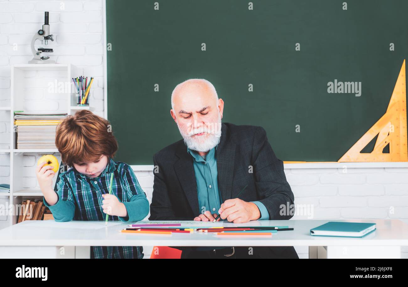 A grandfather and a son are learning in class. Student and tutoring ...