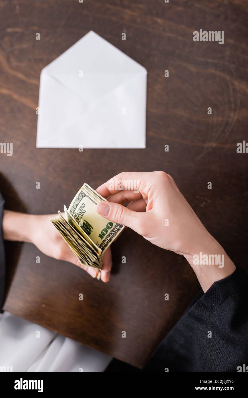 top view of cropped judge counting money near blurred envelope Stock ...