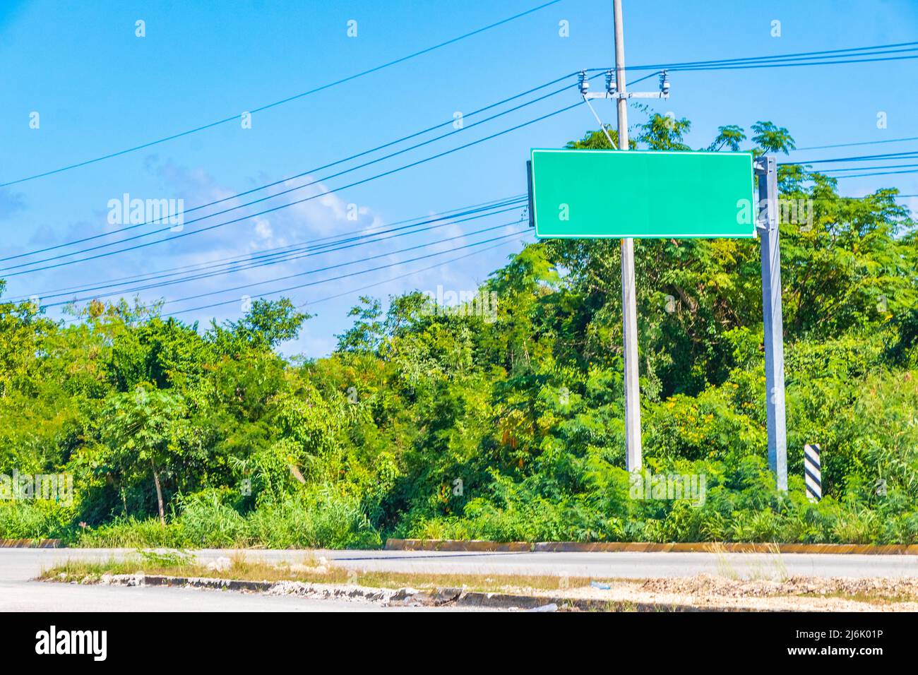 Green turquoise blank empty road sign at the highway from Tulum to ...