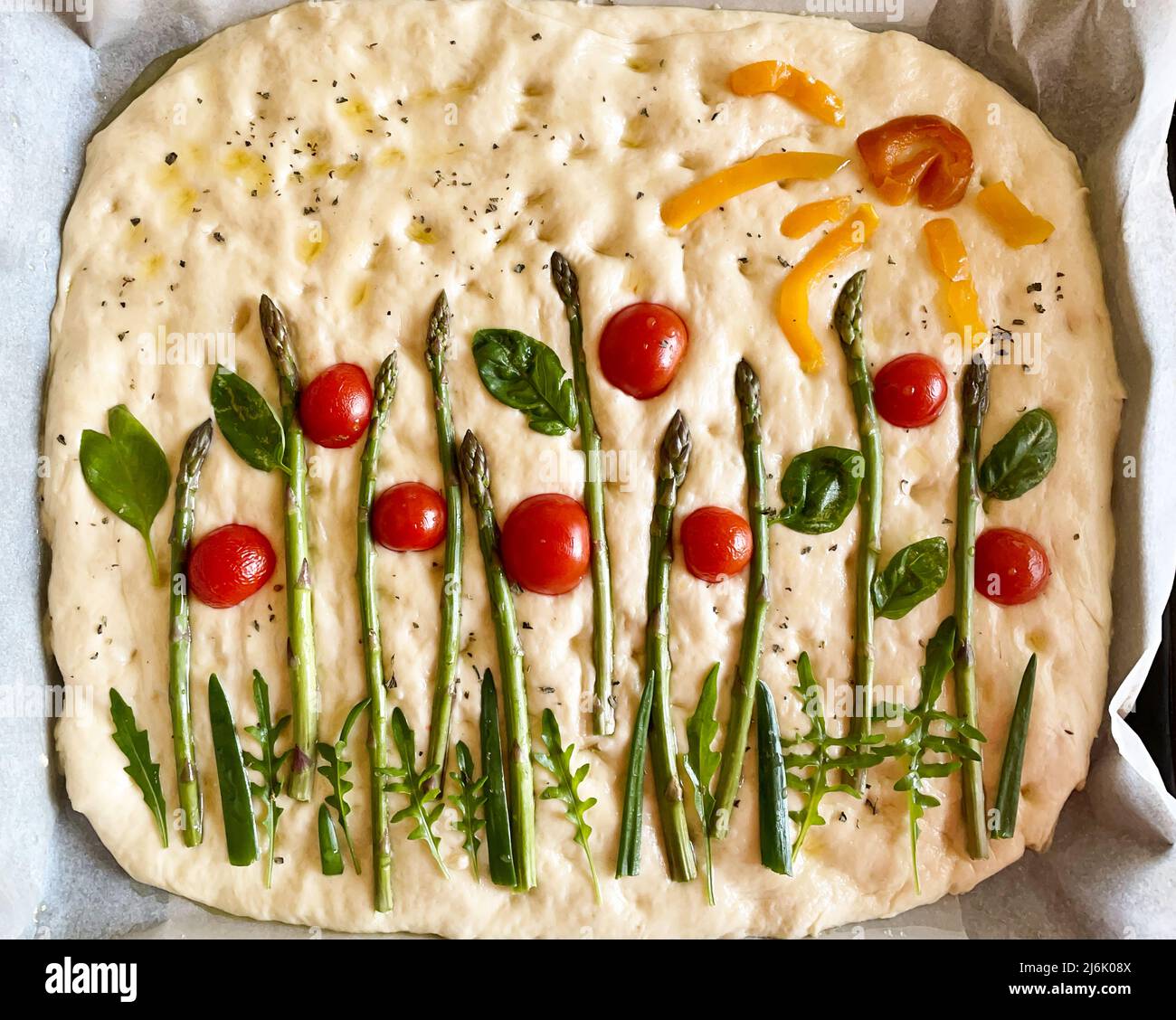 Focaccia art dough with floral vegetable picture on baking tray. Ready ...