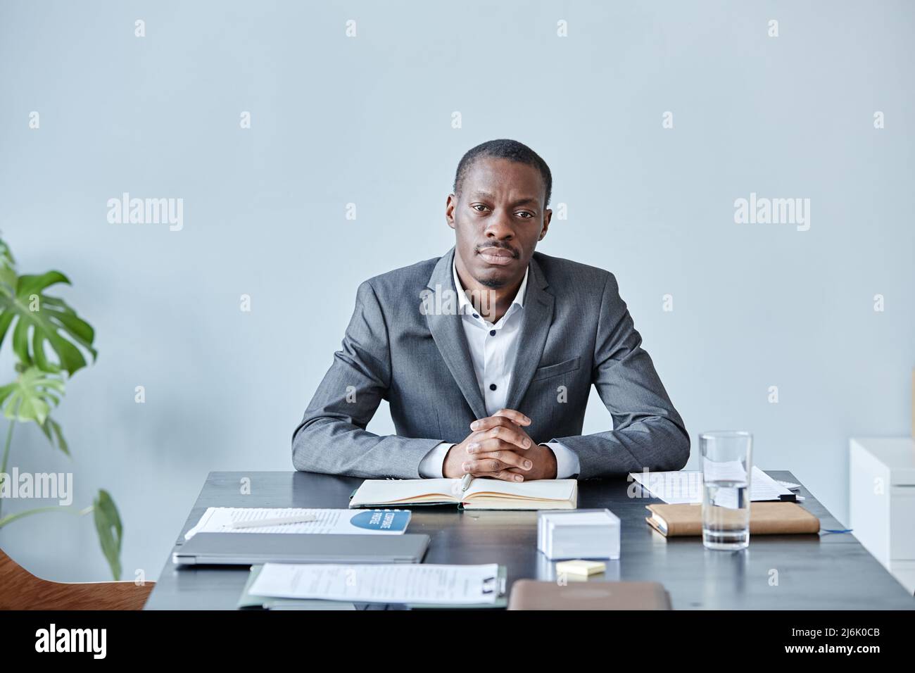 Minimal portrait of professional black businessman looking at camera ...