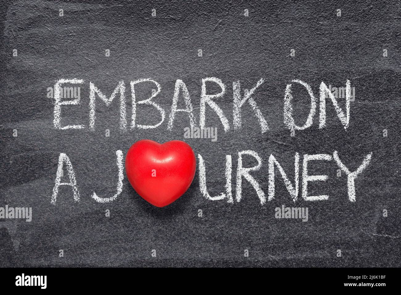 embark on a journey phrase handwritten on chalkboard with red heart ...