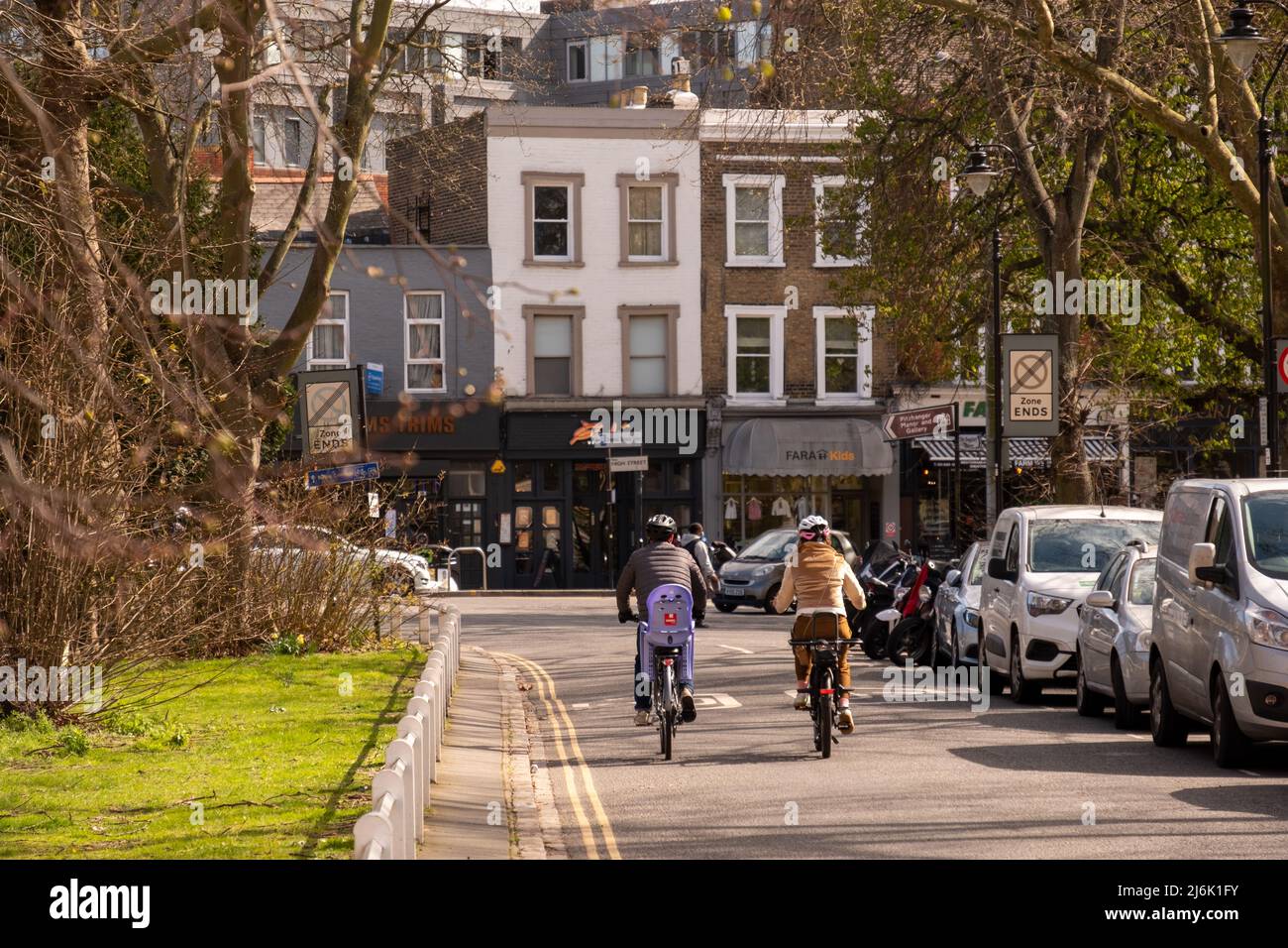 LONDON April- Ealing high street shops on a sunny day, an attractive ...