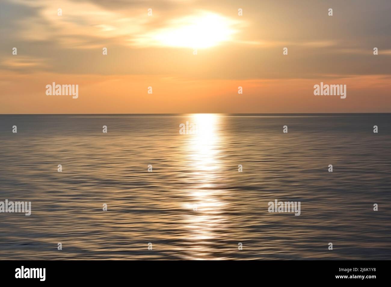 Sunset over the ocean. Blurry ocean landscape background and sunset ...